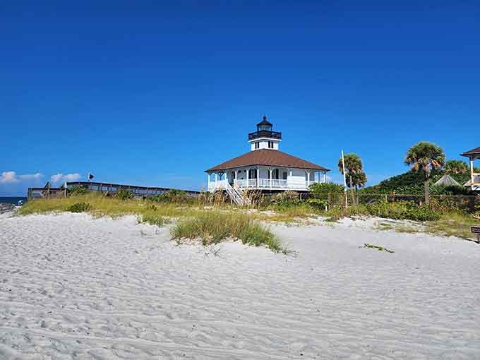 The Port Boca Grande Lighthouse sits pretty against dunes, looking like a postcard that came to life.