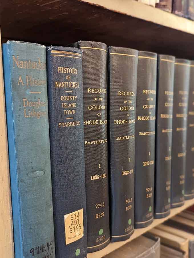 Leather-bound volumes lined up like soldiers, each spine telling stories of Nantucket and Rhode Island's fascinating past.