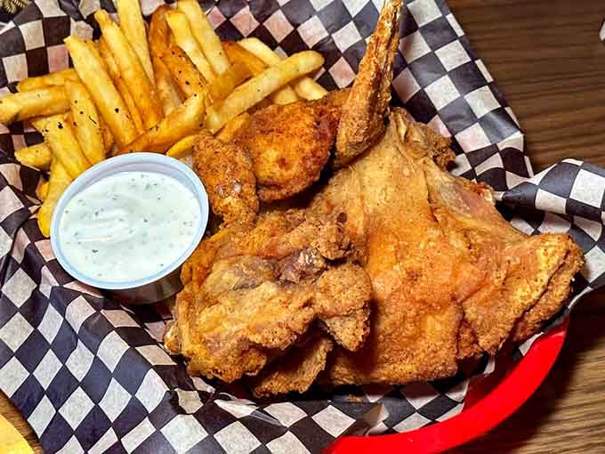 Crispy fried chicken with perfectly golden fries served in a basket lined with classic checkered paper perfection.