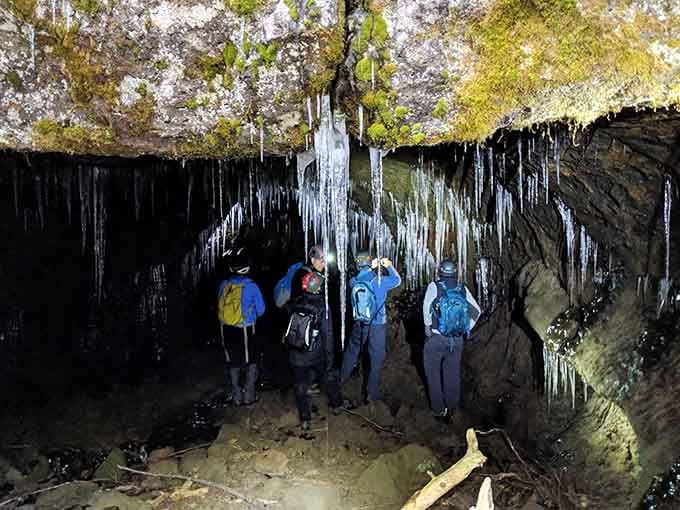 Nothing says "we found it" quite like a group of explorers marveling at nature's frozen chandelier display.