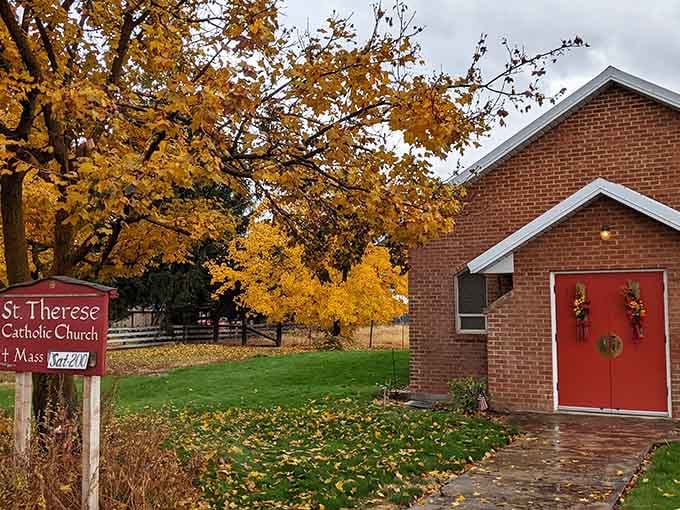 St. Therese Catholic Church glows warmly against fall foliage, a spiritual anchor in this tight-knit mountain community.
