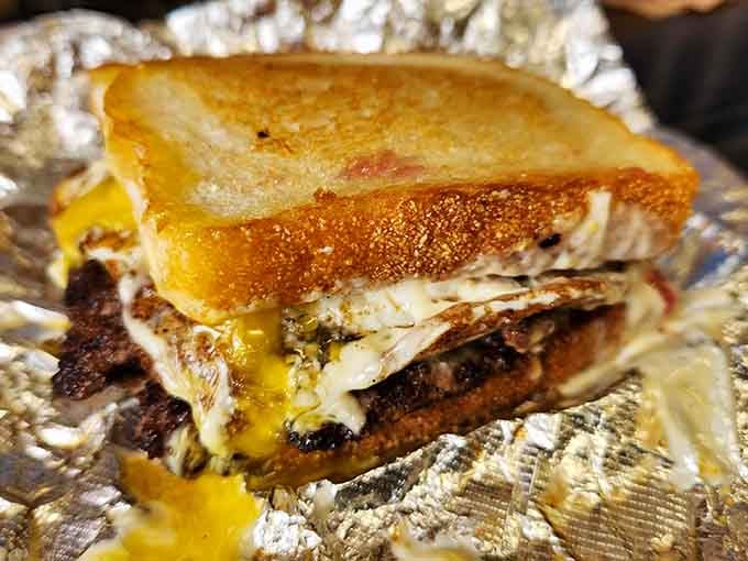 Grilled bread, oozing cheese, and a burger patty walk into a bar, this beautiful hybrid is the punchline.
