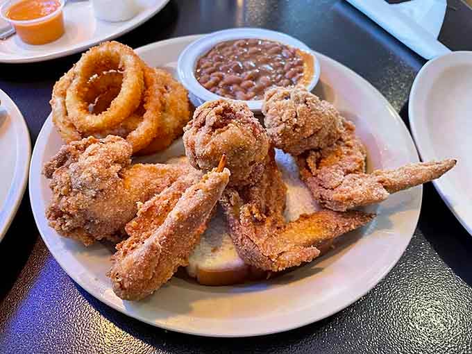 Chicken wings and onion rings sharing a plate like the dynamic duo of deep-fried deliciousness they were born to be.
