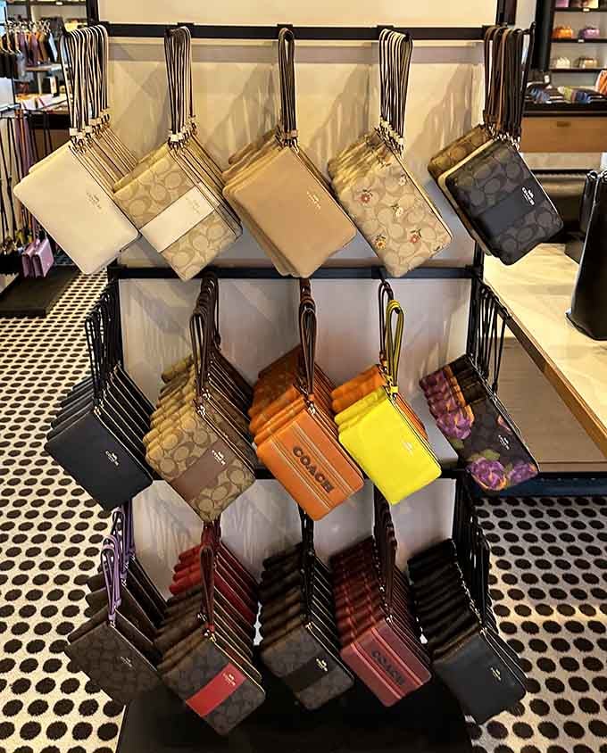 Coach wristlets hanging like colorful temptations, each one whispering "you deserve this" in your fiscally responsible ear.