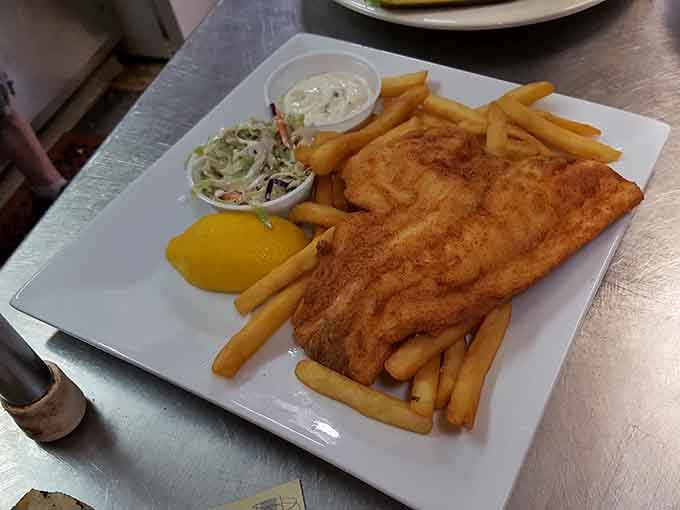 The fish and chips arrive golden and crispy, proving this tavern knows its way around more than just beef patties.