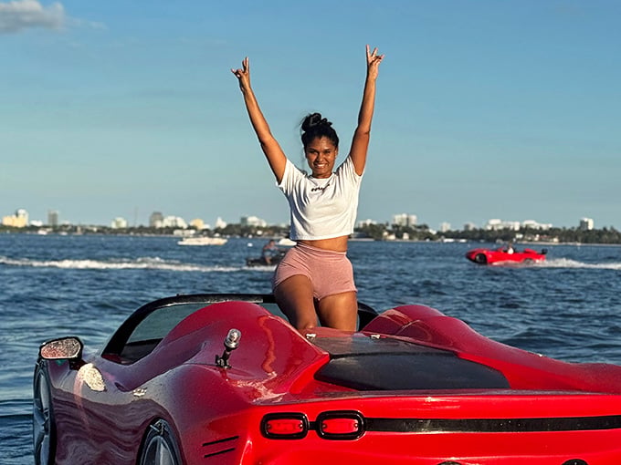 Pure joy looks like standing on a floating Corvette with your arms up, living your best aquatic life.