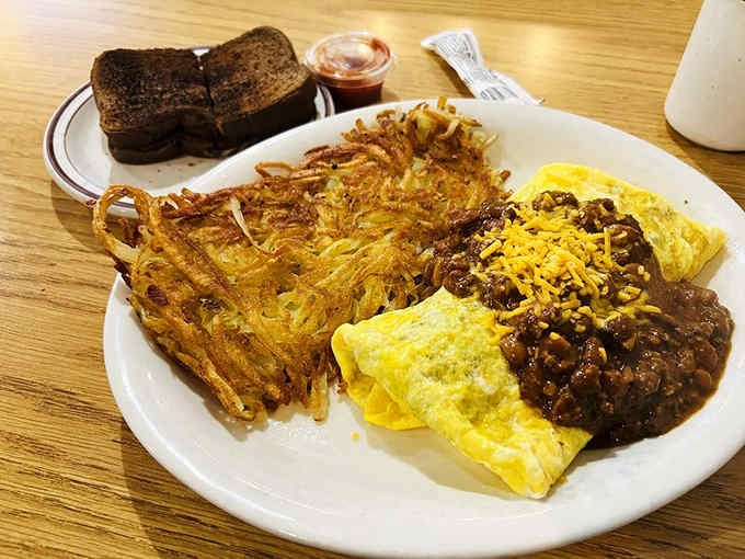 The Texas Omelet arrives smothered in chili and cheese, because everything's bigger and bolder in Texas.