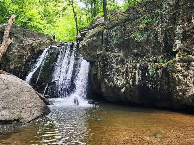 Spring's generous flow transforms the falls into a thundering spectacle framed by ancient stone walls and emerald moss.