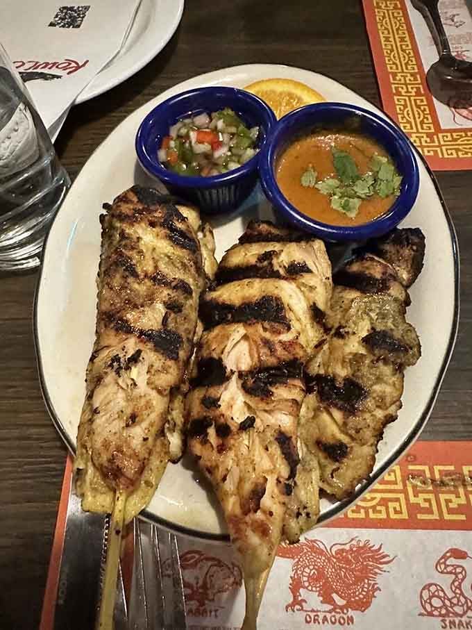 Chicken Satay skewers bring char-grilled satisfaction with dipping sauces that deserve their own standing ovation and encores.