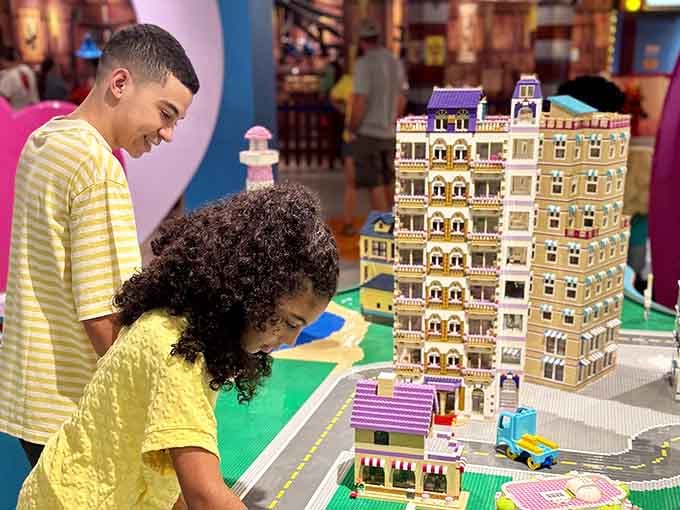 Young builders examine miniature cityscapes, learning that patience and precision create something truly magnificent.