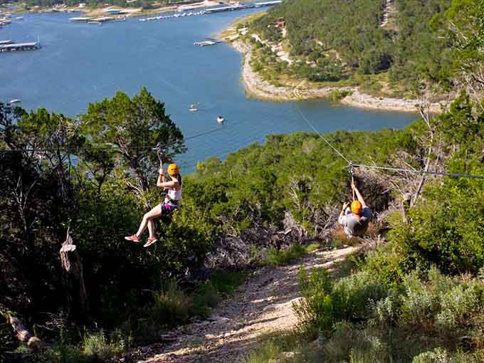 Gliding over Hill Country terrain with Lake Travis sparkling below like nature's own welcome mat for thrill-seekers.
