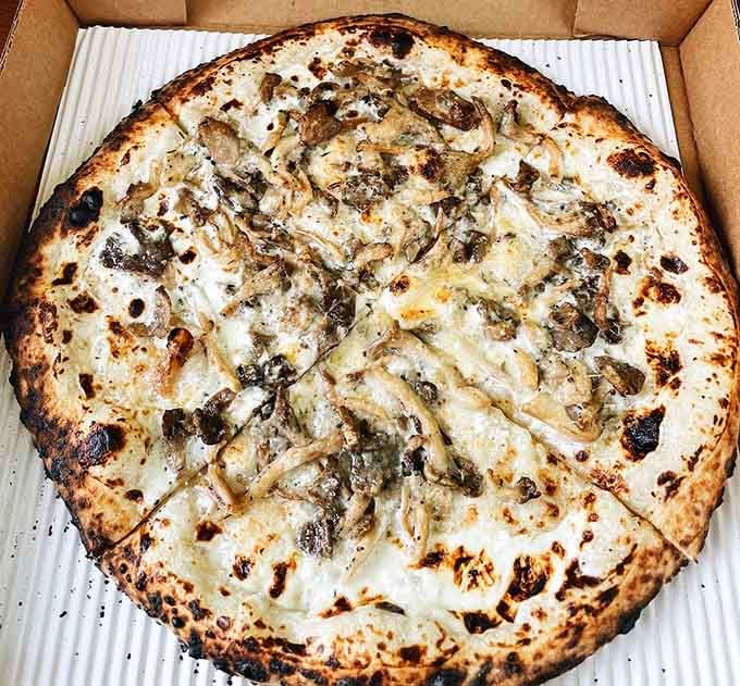 The Funghi pie showcases earthy mushrooms and creamy cheese on that signature blistered, airy Neapolitan crust.