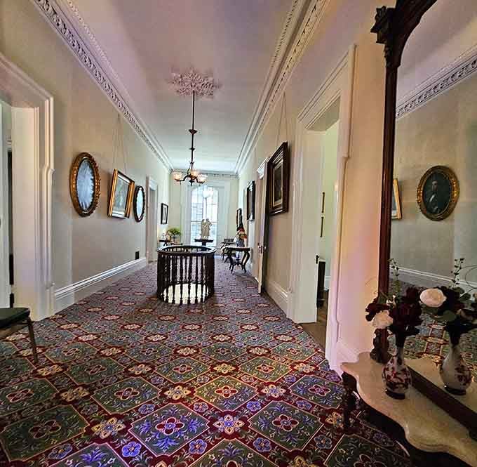 Walking this portrait-lined hallway with its patterned carpet feels like stepping into a Victorian-era episode of "This Old House."