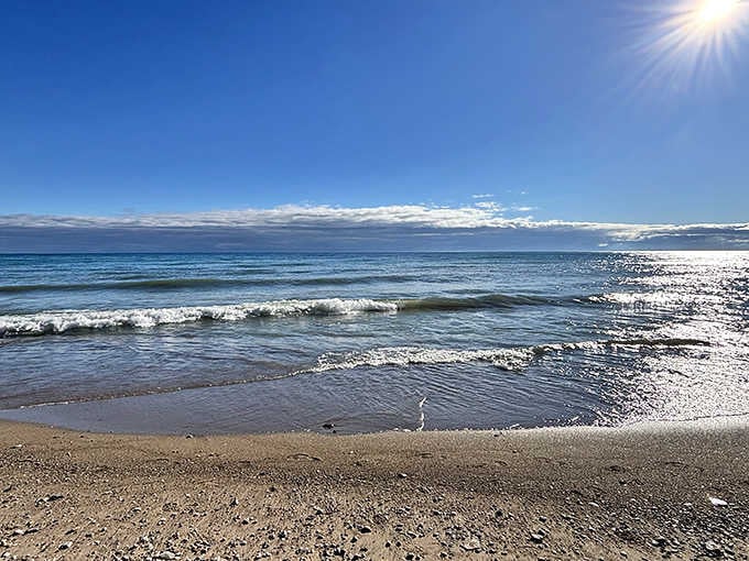 Gentle waves kiss the shoreline while the sun plays peek-a-boo, creating the kind of moment cameras were invented for.