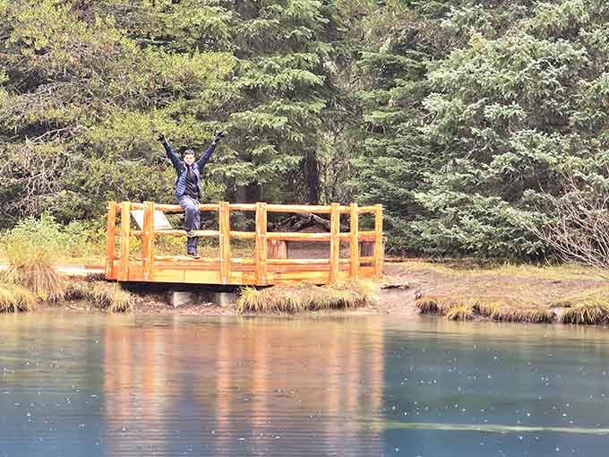 Finding your happy place sometimes means standing beside impossibly blue water surrounded by towering evergreens and silence.
