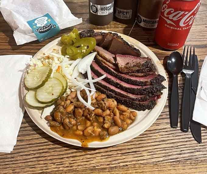 Sliced brisket revealing that coveted pink smoke ring proves patience and skill create something truly extraordinary here.