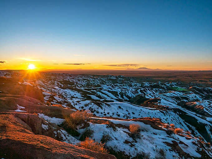 Winter snow dusts the formations like powdered sugar on a very large, very colorful geological dessert nobody ordered.