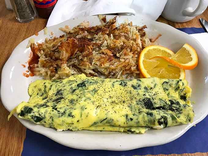 Spinach omelet so fluffy it practically floats off the plate, proving vegetables can be breakfast stars too.