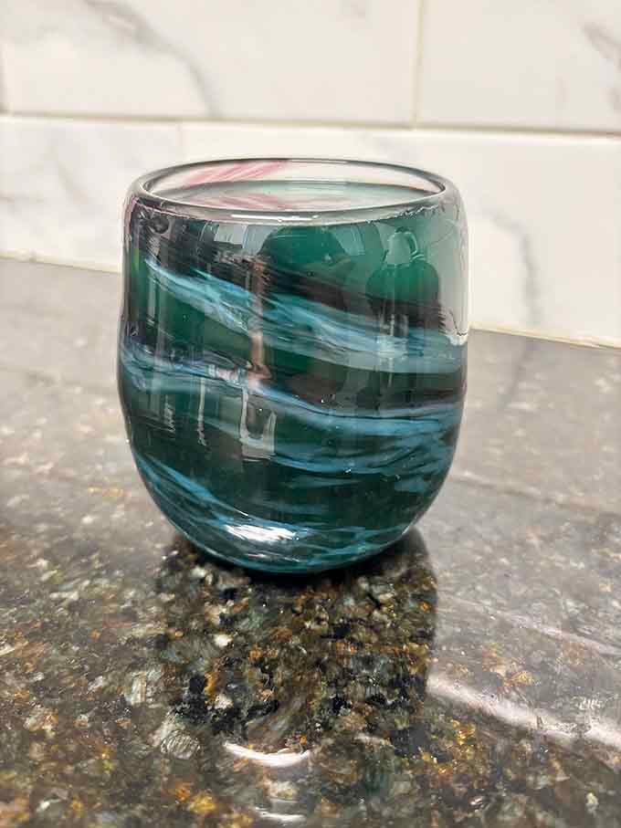 This swirled green glass captures ocean waves frozen in time, a testament to the artist's mastery.
