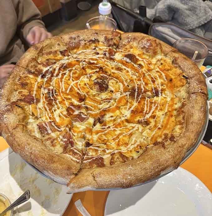 Buffalo chicken on pizza with that gorgeous drizzle pattern proves some rules were meant to be deliciously broken.