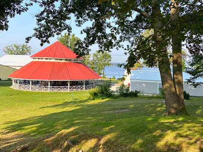 That distinctive red roof sheltering the carousel pavilion, framed by lake breezes and trees older than most theme parks combined.