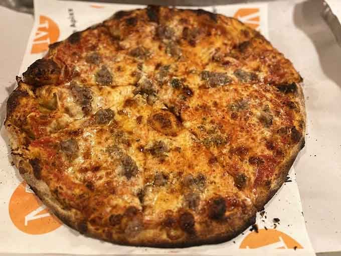 When sausage meets coal-fired crust, magic happens in ways that'll make you forget every other pizza.