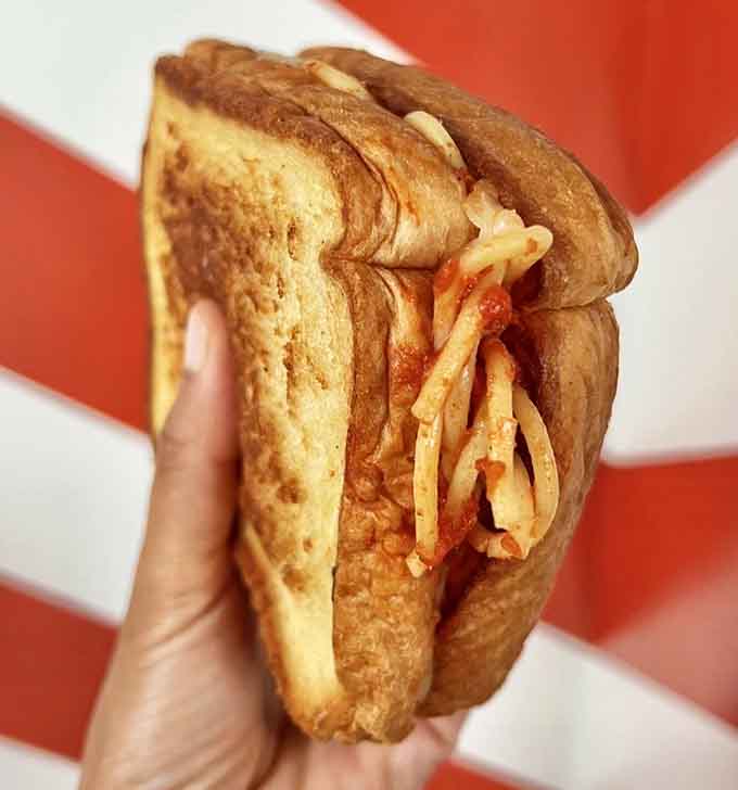 This is what happens when comfort food meets pure genius: spaghetti tucked between toasted bread like it's been waiting its whole life for this moment.