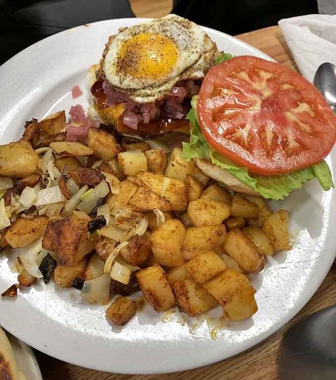 A fried egg crowning a burger with homefries on the side is the kind of genius that deserves a standing ovation.
