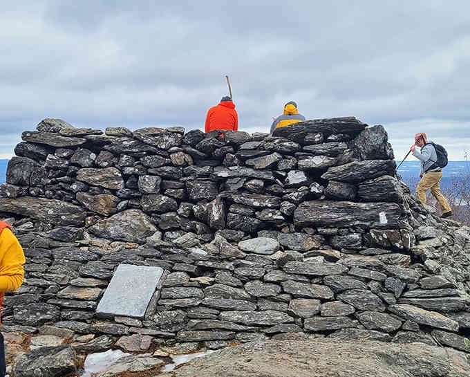 That stone cairn marks the summit where hikers celebrate like they've just conquered Everest, Connecticut-style.