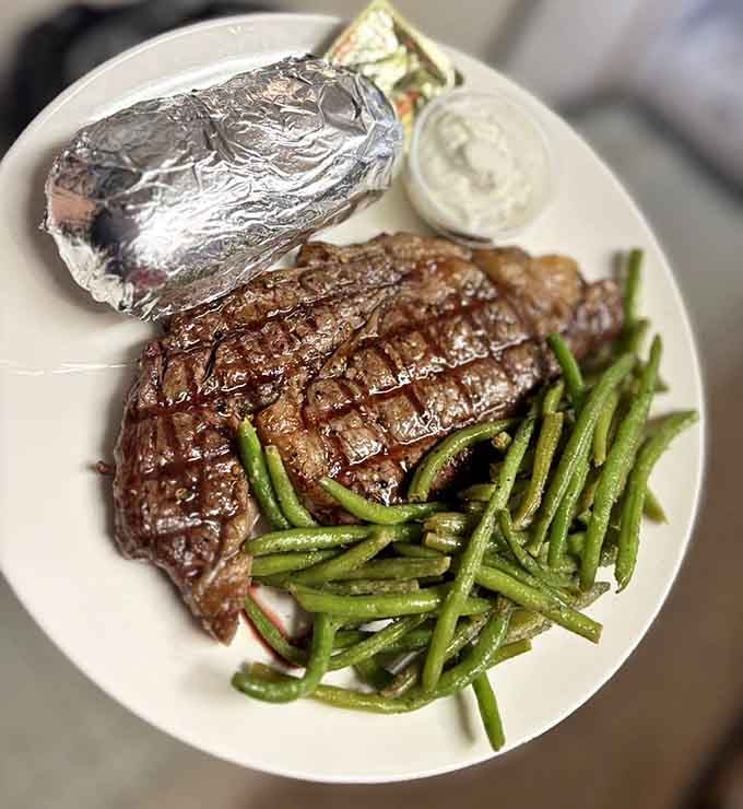 When your steak needs its own zip code and comes with perfectly cooked green beans, life is good.