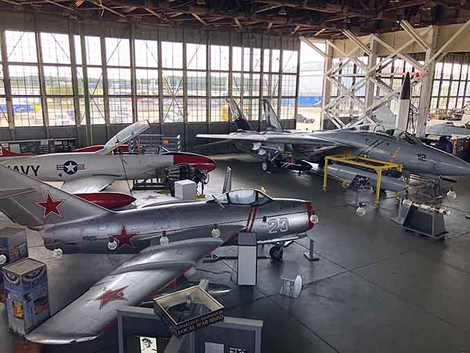 Multiple generations of naval aviation sharing one roof, like a family reunion where everyone actually gets along perfectly.