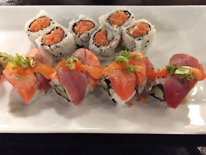 The Rainbow Roll draped in fresh fish looks like edible art, proving sushi can be both beautiful and delicious simultaneously.