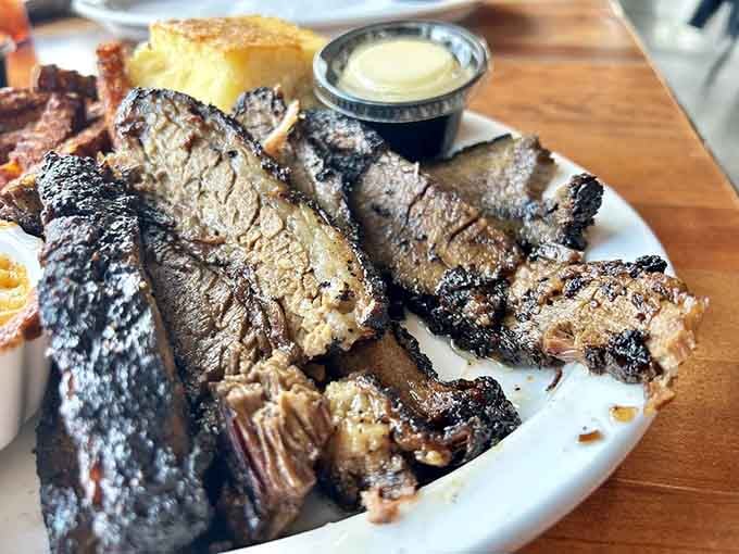Brisket with that perfect smoke ring and bark, looking like it just won the lottery of low-and-slow cooking.