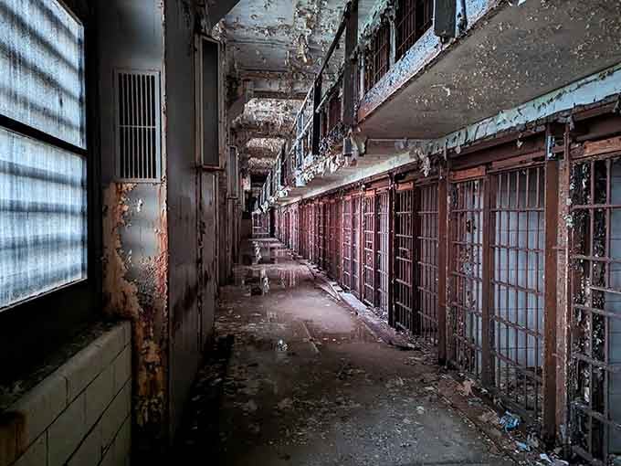 Peeling paint and rusted bars tell stories that tour guides can only hint at in this haunting corridor of cells.
