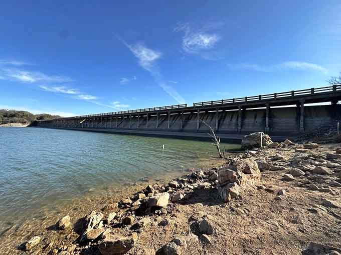 Lake Cisco's dam provides a scenic backdrop, because even abandoned zoos deserve a water view, apparently.