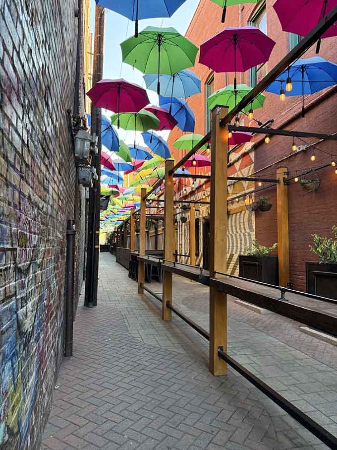 Outdoor moments get a serious upgrade when your view is a floating kaleidoscope of cheerful umbrellas overhead.