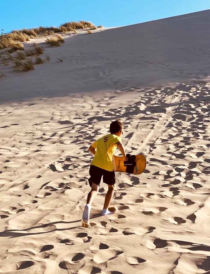 Sandboarding down these slopes beats any water slide, and the only splash you'll make is in the soft landing below.