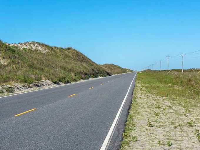 The dunes tower beside the highway like nature's own guardrails, constantly reshaping themselves with every ocean breeze.