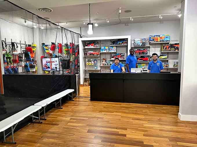 The command center displays an impressive arsenal, where families gear up and staff members prepare participants for glorious foam combat ahead.