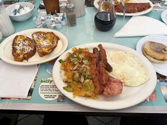 A breakfast spread worthy of champions: eggs, bacon, hash browns, and French toast all playing together beautifully.