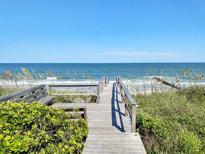 Your wooden pathway to sanity, where flip-flops are formal wear and stress evaporates with each sandy step.