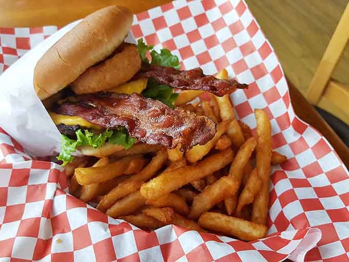 Bacon, cheese, and a perfectly cooked burger on a mountain of fries, this is happiness on a plate.