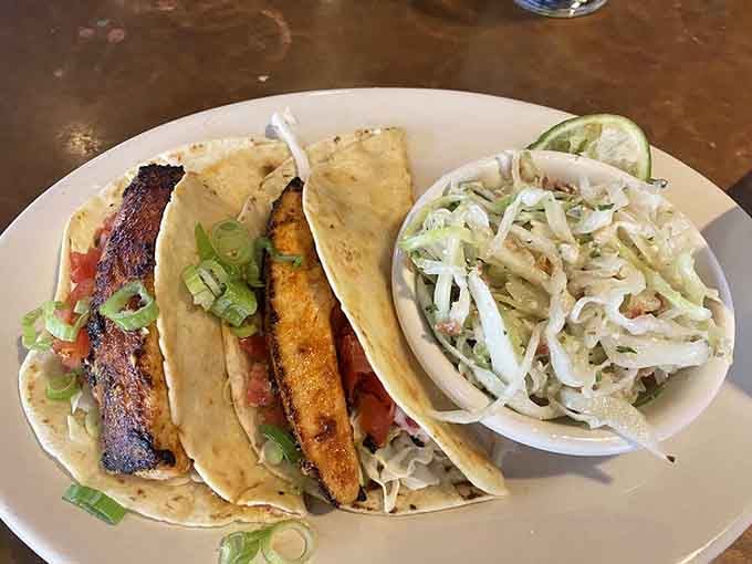Perfectly seasoned fish nestled in soft tortillas with crisp slaw proves tacos transcend all regional boundaries beautifully.