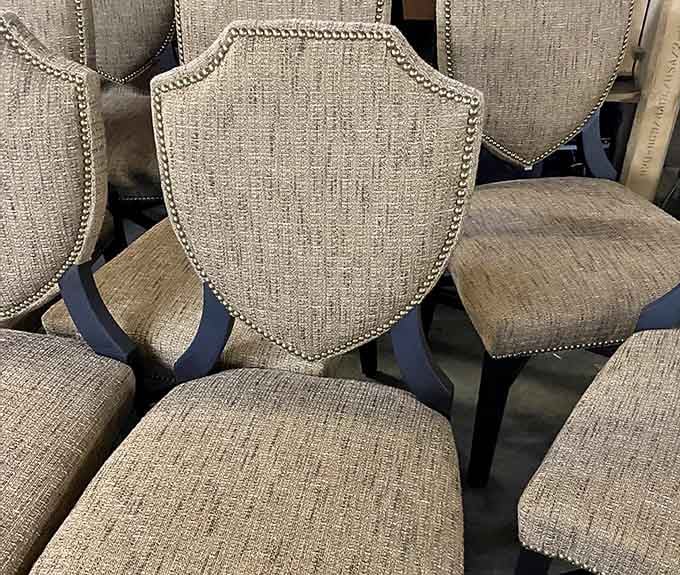 Upholstered chairs with nailhead trim that screams quality craftsmanship you simply cannot find at big-box stores anymore.