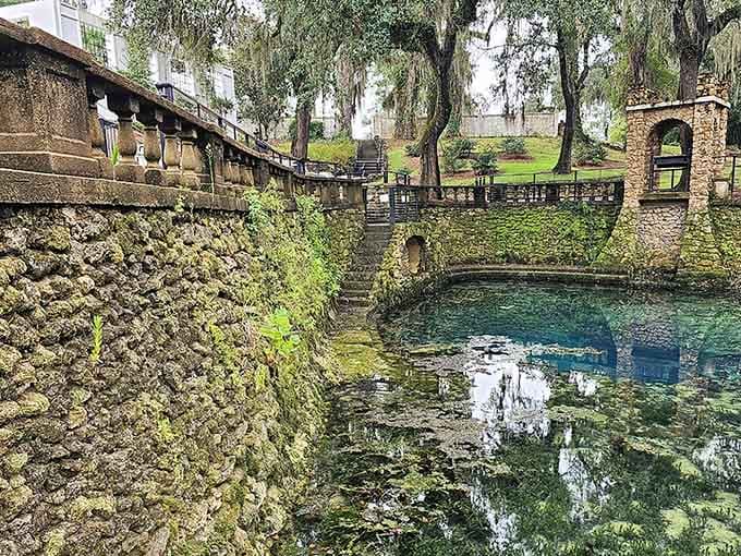 Stone pillars framing crystal water: architecture and nature finally agreeing on something for once here.