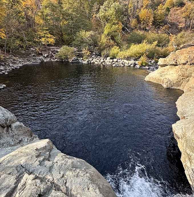 Autumn transforms the swimming hole into a mirror reflecting gold and amber, like nature's own jewelry box.