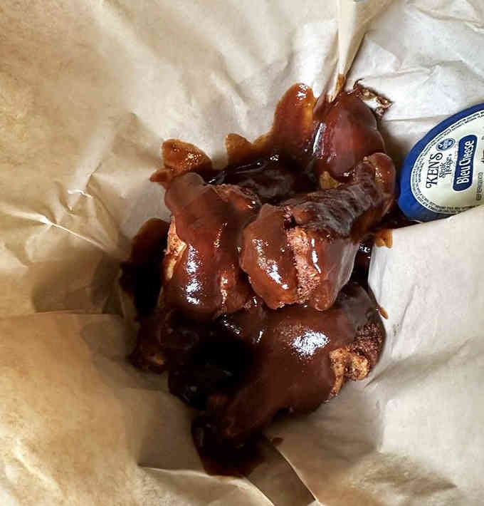 These buffalo wings glisten with sauce, sticky fingers guaranteed and completely worth it.