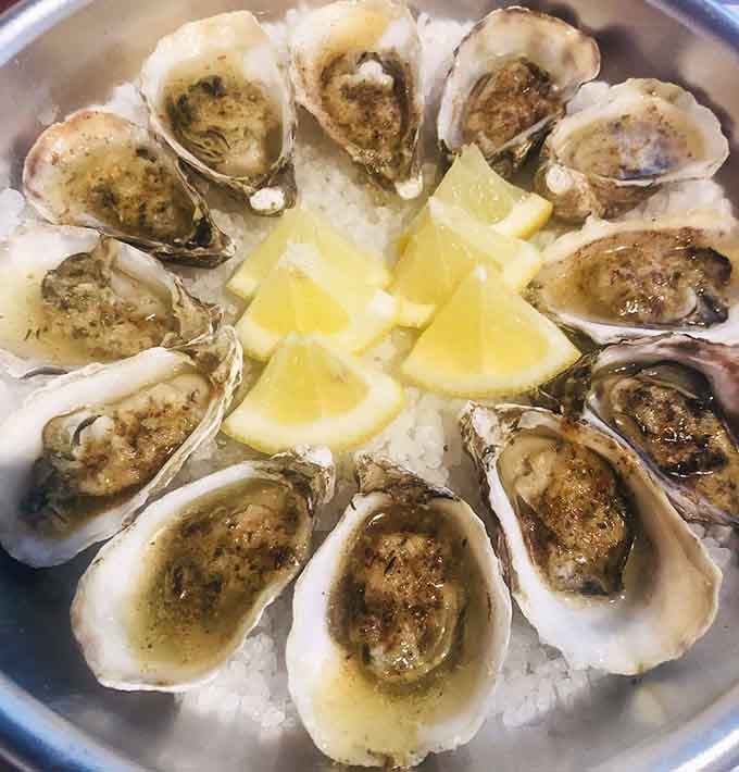 Fresh oysters on ice with lemon wedges, because sometimes the ocean's simplest offerings are the most sublime.
