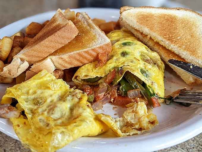 This omelet comes loaded with vegetables and possibilities, served alongside toast and enough home fries to fuel your day.