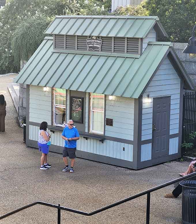 That charming little ticket kiosk is where your canal adventure begins, no fancy app required, just good old-fashioned human interaction.